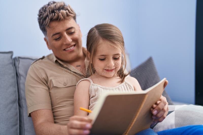 Father and Daughter Father and Daughter Writing on Notebook at Home ...