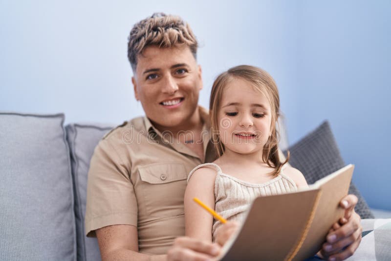 Father and Daughter Father and Daughter Writing on Notebook at Home ...