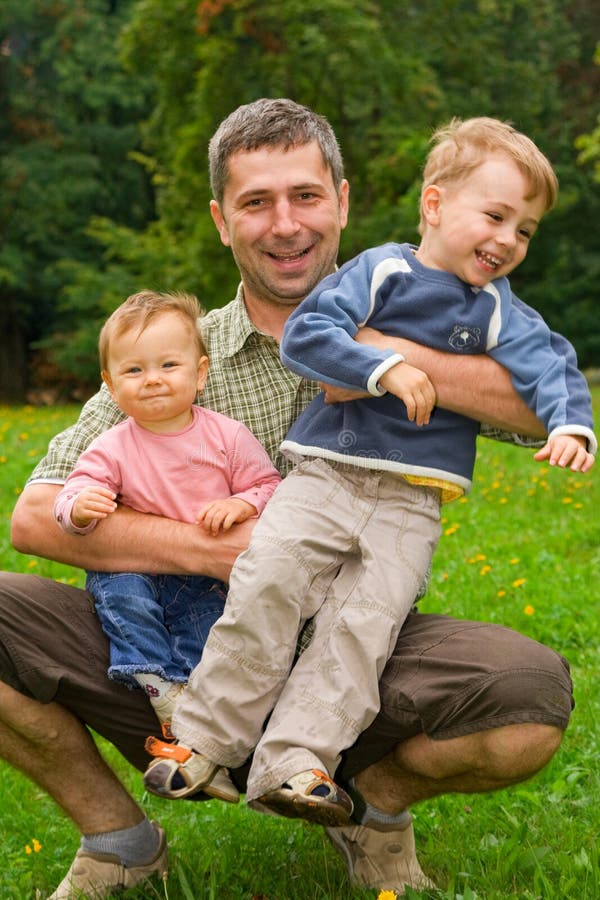 Father embracing children stock image. Image of parent - 6219579