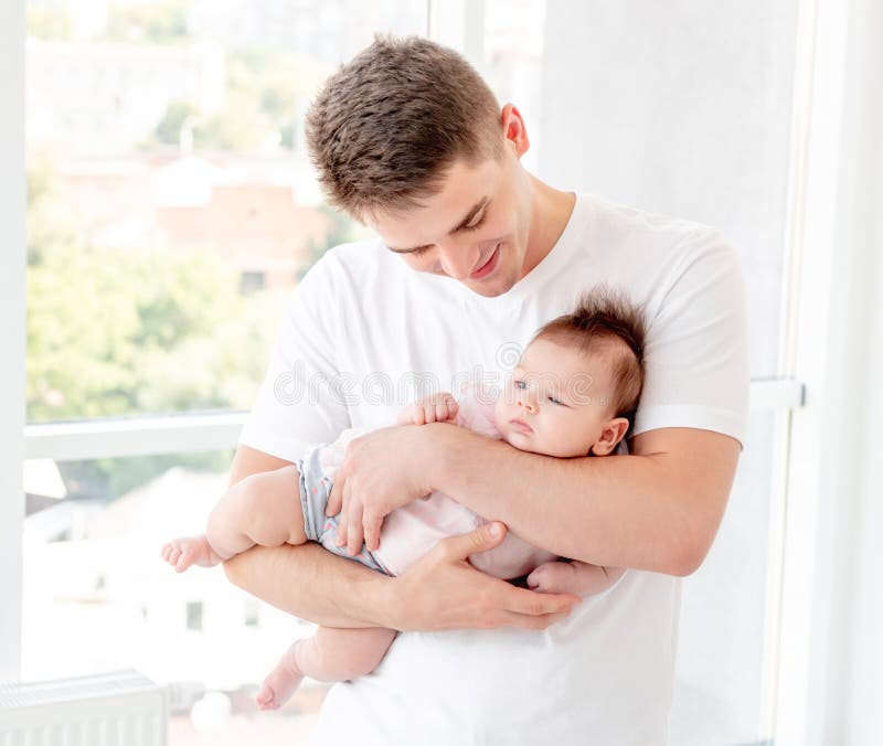 Father embracing infant stock image. Image of adorable - 165278067