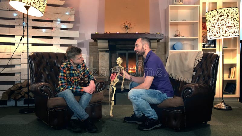 Father Explaining His Elder Son the Bone Structure of Human Body ...
