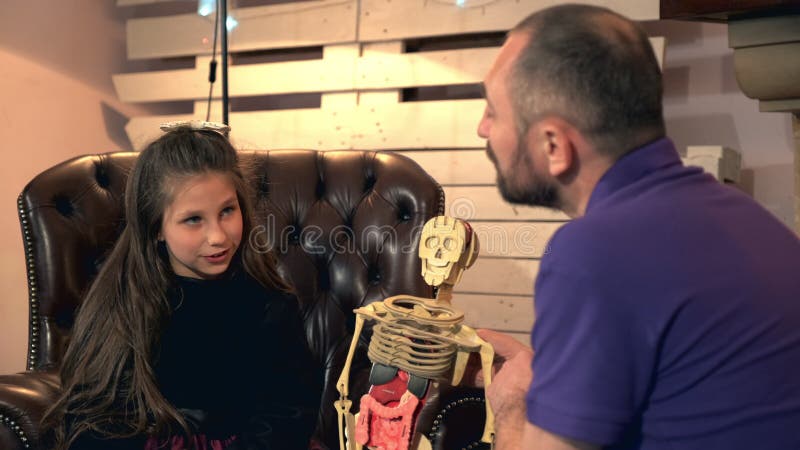 Father Explaining His Younger Daughter the Bone Structure of Human Body ...