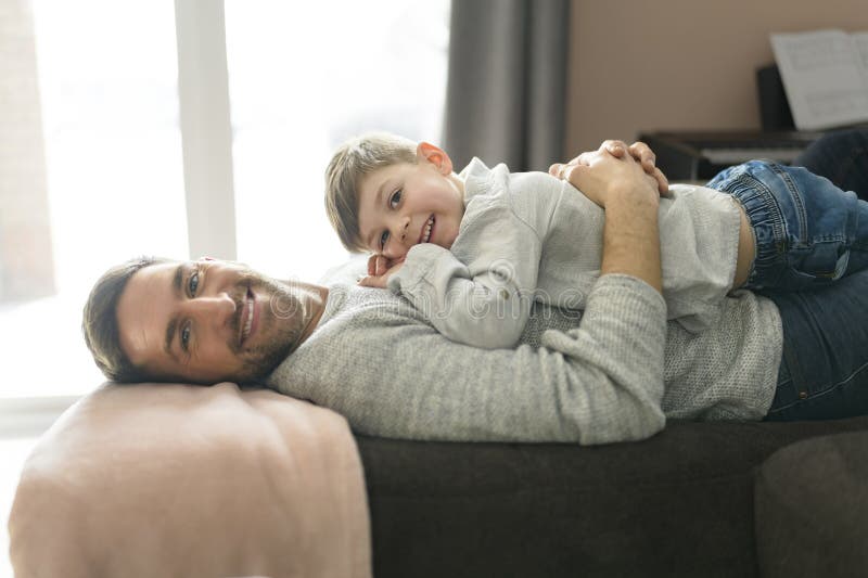 Father or Godfather Having Fun Relaxing on the Living Room at Home ...