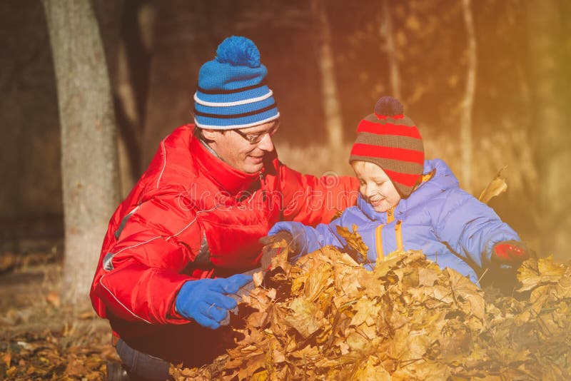 Father and Happy Little Son Playing in Autumn Leaves Stock Photo ...