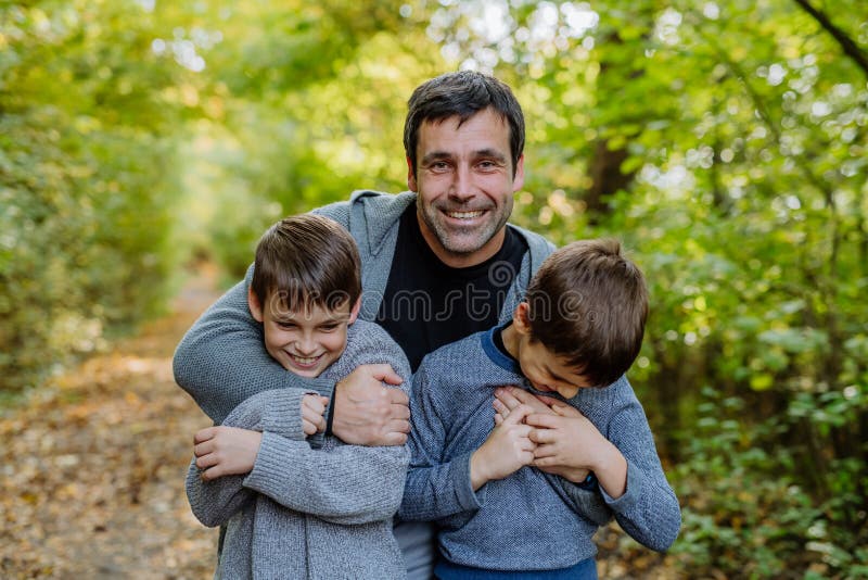 Father Having Fun with His Sons in Forest. Stock Photo - Image of sons ...