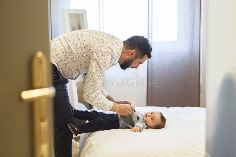 Father Having His Baby Get Dressed for a Special Occasion Stock Image ...