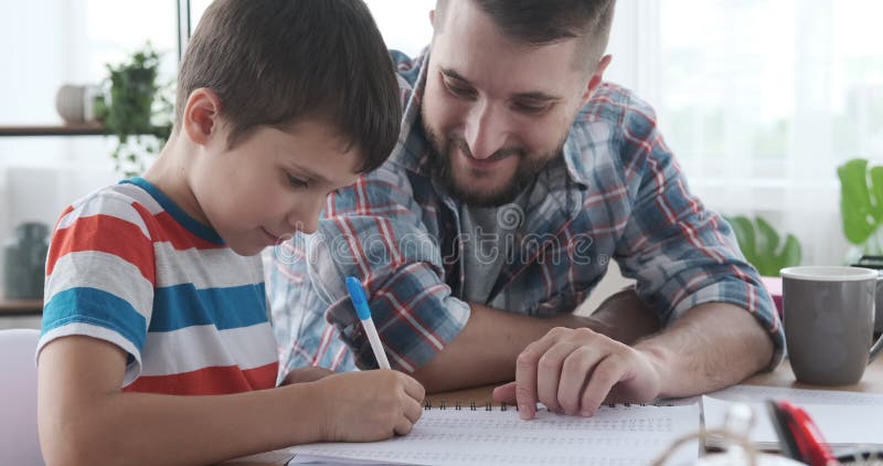 Father with Son Doing Homework in School Book Stock Footage - Video of ...