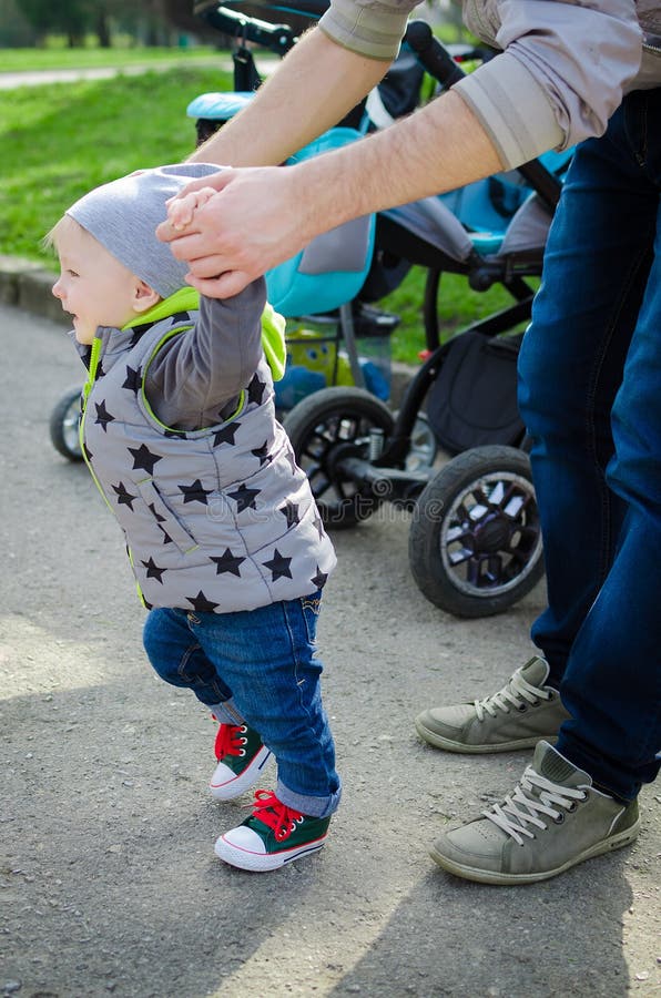 Father Helping His Son for the First Steps Stock Photo - Image of ...
