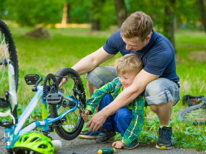 Father Helping His Son Fix Bicycle Stock Photo - Image of lifestyle ...