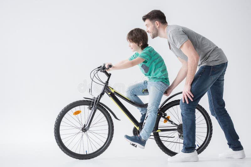 Father Helping Son To Ride Bicycle on White Stock Photo - Image of ...