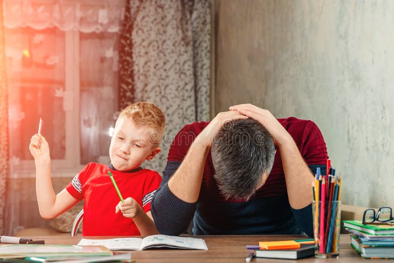 The Father Helps His Son To Do Homework for the School. Stock Photo ...