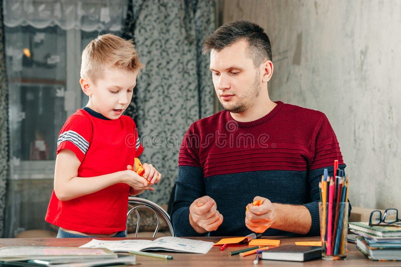 The Father Helps His Son To Do Homework for the School. Stock Image ...