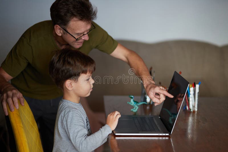 Father Helps His Son Use a Laptop. Stock Image - Image of internet ... Father Helps His Son Use a Laptop. Stock Image - Image of internet ...
