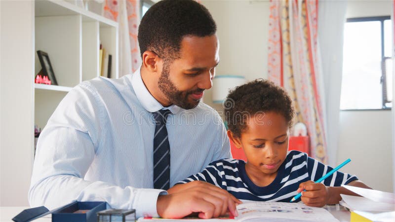 Father Helps Son with Homework Sitting at Desk in Bedroom at Home Stock ...