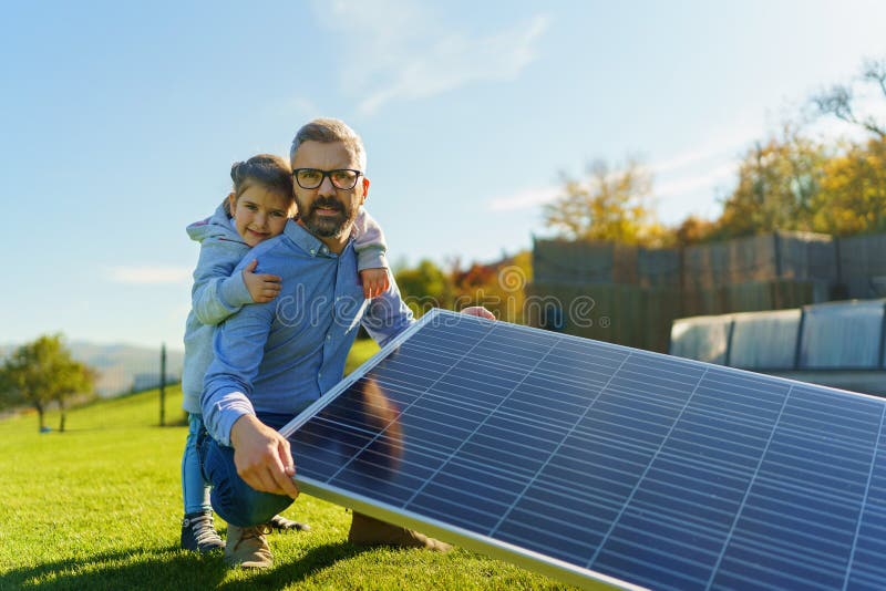 Father with His Little Daughter Catching Sun at Solar Panel,charging at ...