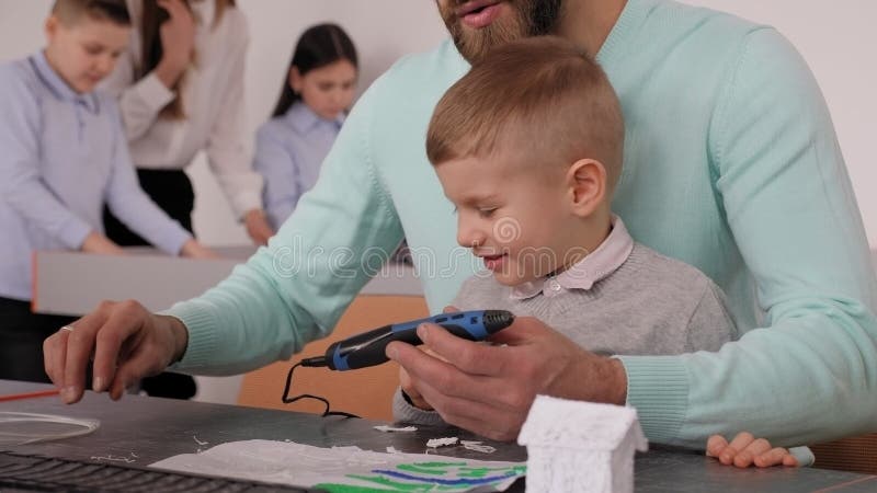 A Father and His Little Son Make a 3d Plastic Model with a 3D Pen in a ...