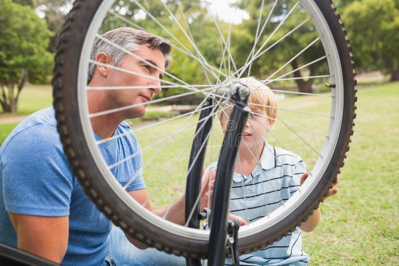 Father and His Son Fixing a Bike Stock Photo - Image of bike, father ...