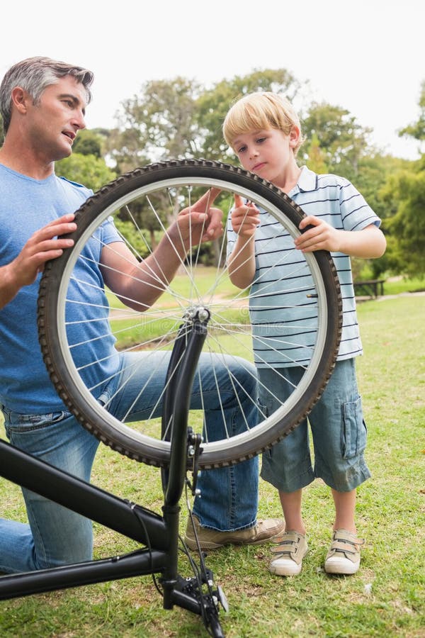 Father and His Son Fixing a Bike Stock Image - Image of mature, spring ...