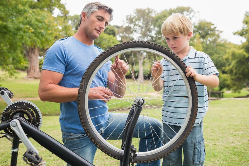 Father and His Son Fixing a Bike Stock Photo - Image of countryside ...
