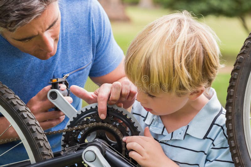 Father and son fixing bike stock image. Image of side - 37375243