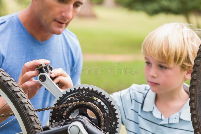 Father and His Son Fixing a Bike Stock Image - Image of park, pursuit ...