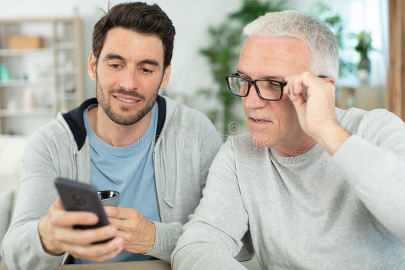 Father and Son Looking at Phone Stock Image - Image of lifestyle, adult ...