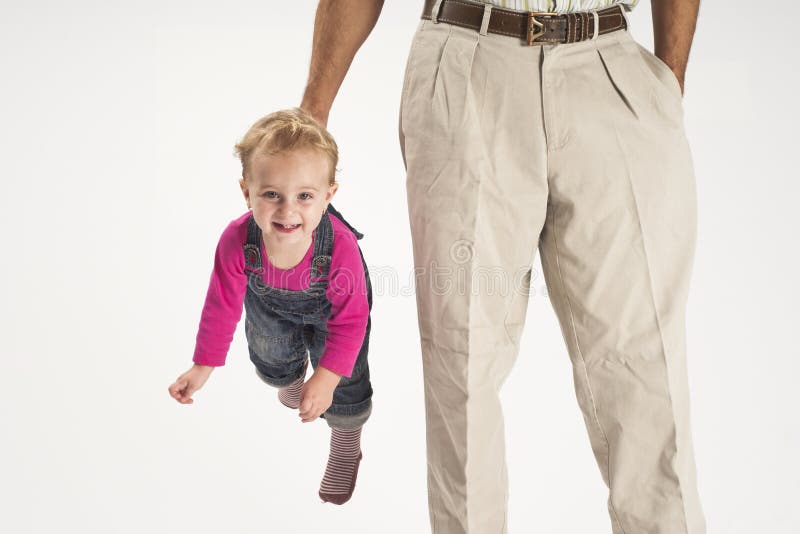 Father Holding Baby Suspended by Suspenders Stock Photo - Image of ...