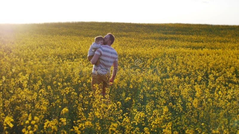 Father and Son Holding Hands Walking Together with Little Brother on ...