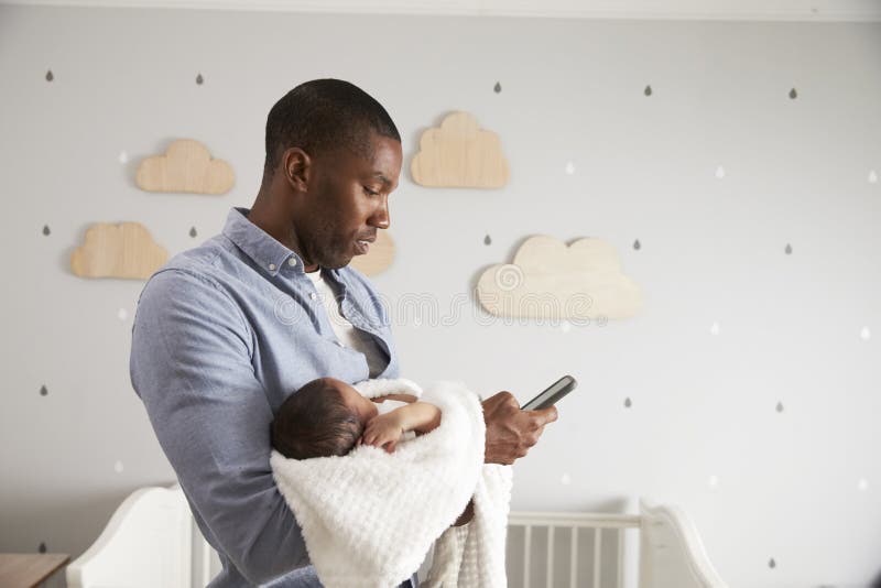 Father Holding Newborn Baby Son Using Mobile Phone Stock Photo - Image ...