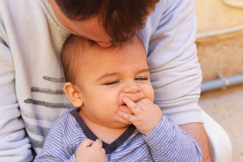 Father Holding Baby Boy, Teething, Grumpy Face Stock Photo - Image of ...
