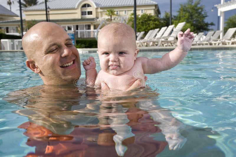 Father Holding Baby Up High in Swimming Pool Stock Photo - Image of ...