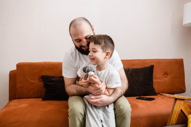 Father Hug Little Boy at Home Sofa Stock Photo - Image of hold, happy ...