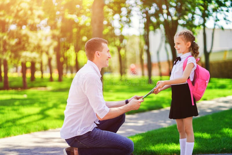 Father Leads Daughter To School in First Grade. First Day at School ...