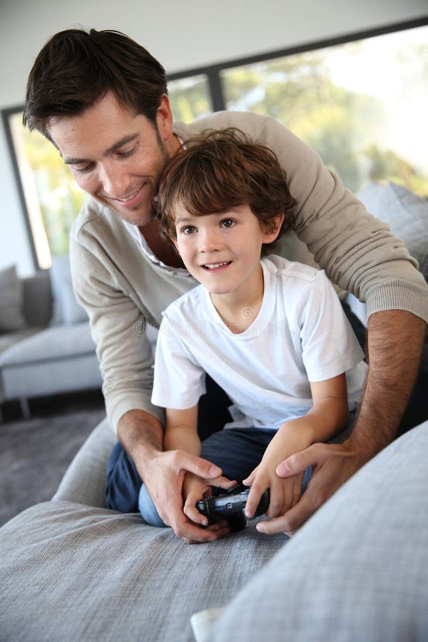 Father and Little Boy Playing Video Game Stock Photo - Image of single ...