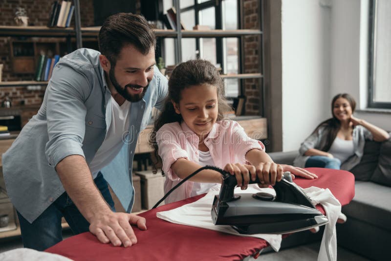 Father with Little Daughter Ironing Clothes at Home Stock Photo - Image ...