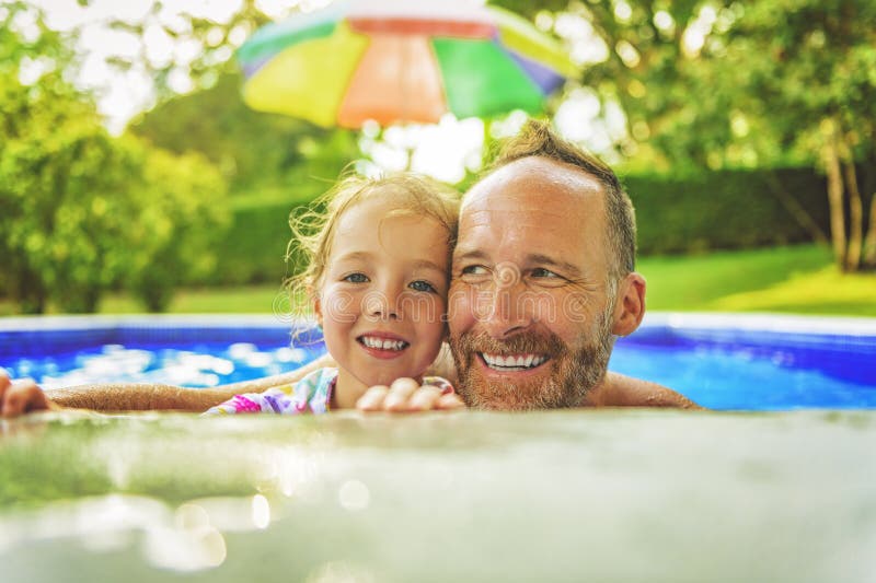 Father with Little Girl in Pool on Sunny Day. Stock Photo - Image of ...