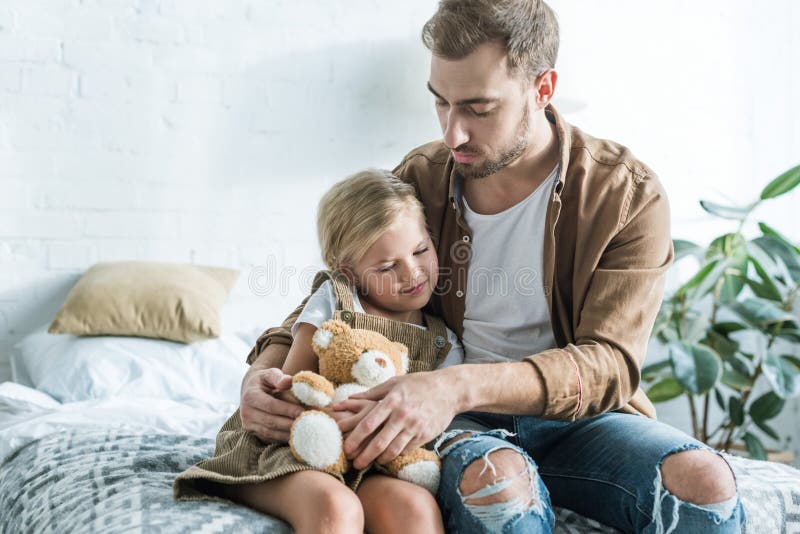 Father Looking at Cute Little Daughter Sitting with Teddy Bear Stock ...