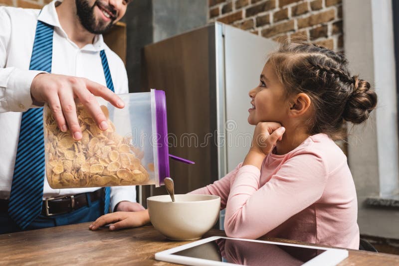 Father Making Cereal Breakfast for Daughter while they Preparing for ...
