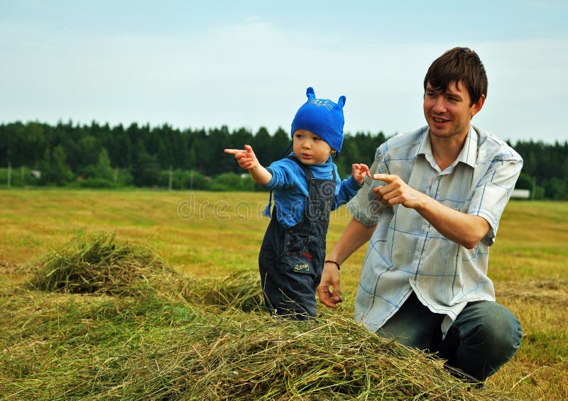 Father Play with Son on Field Stock Photo - Image of male, playful ...