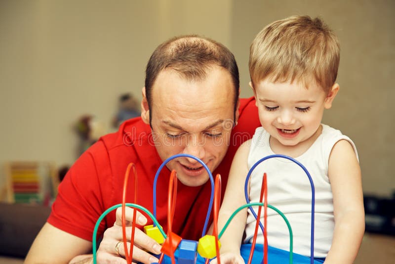 Father Playing with His Child in Developing Game at Home. Dad and Son ...