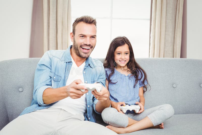 Father Playing Video Game with Daughter at Home Stock Photo - Image of ...