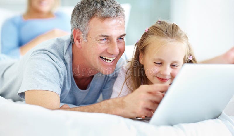 Father Pointing at Laptop Screen with His Daughter Stock Image - Image ...