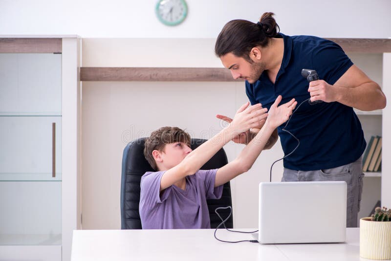 Young Father and Schoolboy Playing Computer Games at Home Stock Photo ...