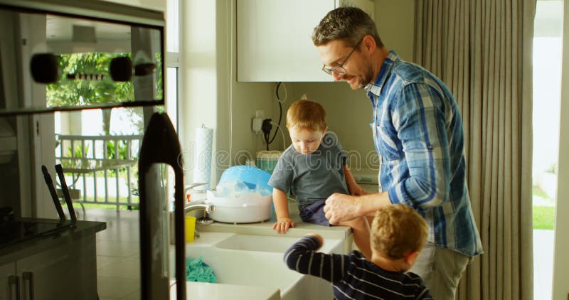 Father and Siblings Cleaning Kitchen Sink 4k Stock Video - Video of ...