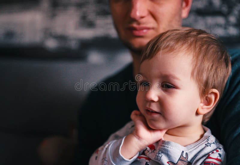 Father Sitting in Armchair and Holding His Baby Stock Photo - Image of ...