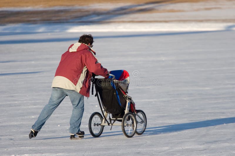 Father Skating with Baby stock image. Image of stroller - 438521