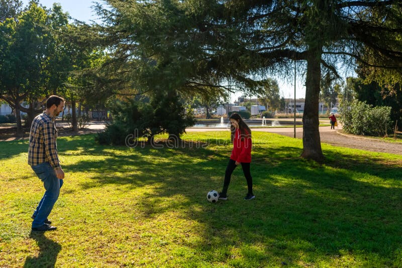 Father with a Small Daughter Playing with a Ball in Spring Nature. Play ...
