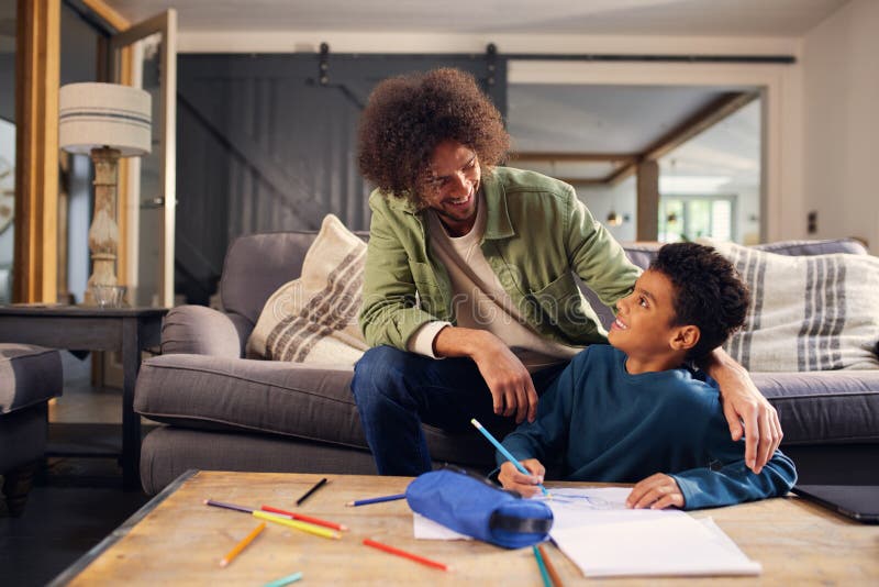 Father Smiling at Son Drawing at Home Stock Photo - Image of homework ...
