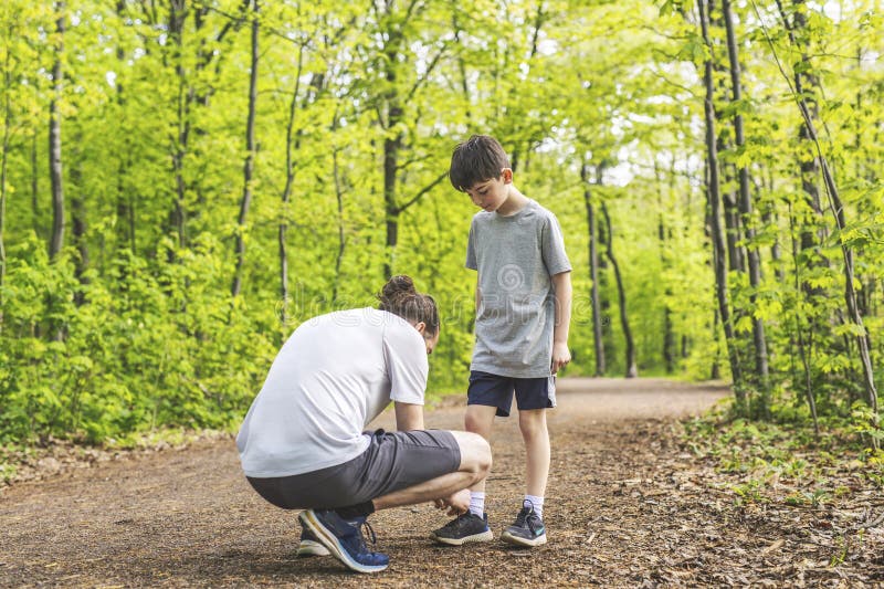 Father and Son Attach Shoes on a Outdoor Park Having Great Fun Stock ...