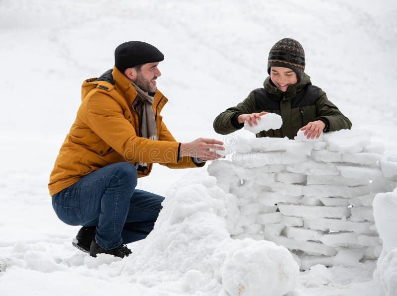 Father and Son Building Structure from Snow Brick Stock Photo - Image ...